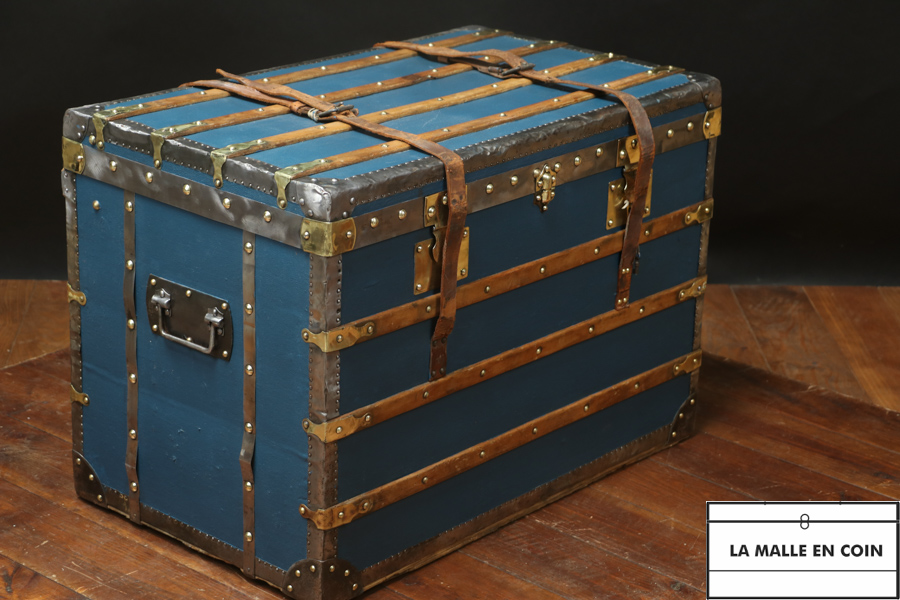 Flat blue steamer trunk with key